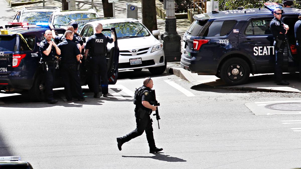 Three Seattle police officers shot after downtown robbery; one suspect ...
