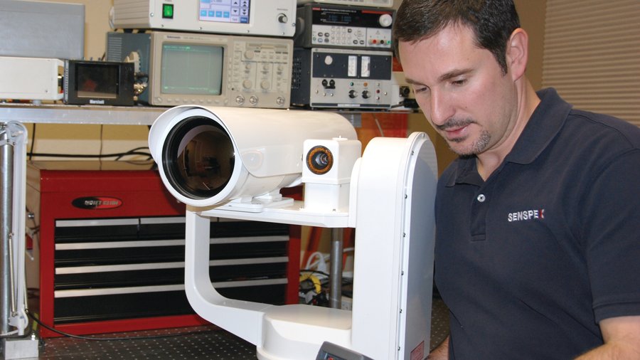 Charles Gloria works on final testing for a thermal imaging camera ...